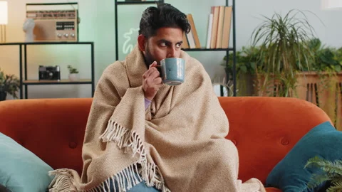 Sick indian man wrapped in plaid shiveri... | Stock Video | Pond5