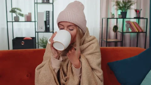 Sick young woman wear hat wrapped in pla... | Stock Video | Pond5