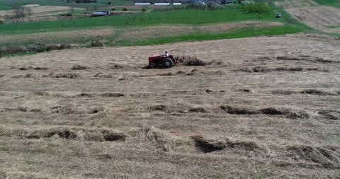 Side aerial view of tractor going throug... | Stock Video | Pond5