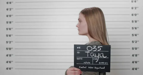 Side profile mugshot of female person ho... | Stock Video | Pond5
