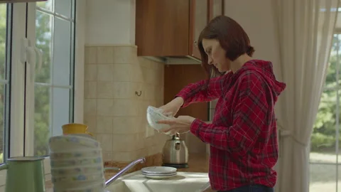 Side view of 30s woman in red shirt wash... | Stock Video | Pond5