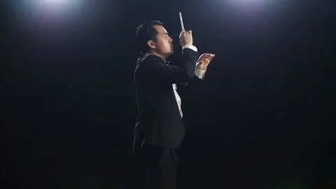 Side View Of Asian Conductor Man Holding... | Stock Video | Pond5