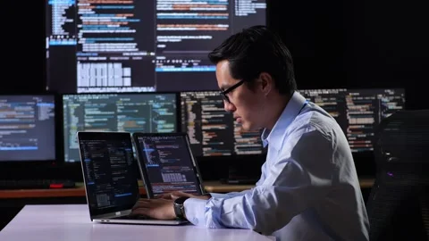 Side View Of Asian Male Programmer Looki... | Stock Video | Pond5