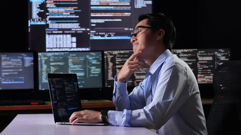 Side View Of Asian Male Programmer Looki... | Stock Video | Pond5