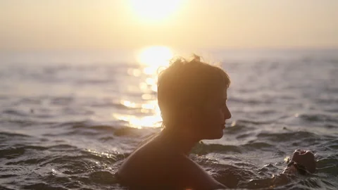 Side View Of A Boy Swimming At The Beach | Stock Video | Pond5