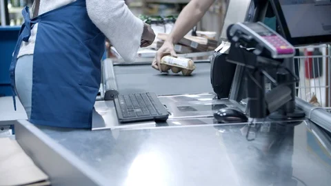 Side view of cashier scanning goods at c... | Stock Video | Pond5
