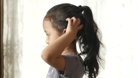 side view of child girl Scratching Head ... | Stock Video | Pond5