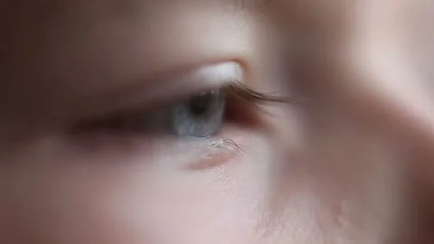 Side view of a child's eyes. An 8-year-o... | Stock Video | Pond5