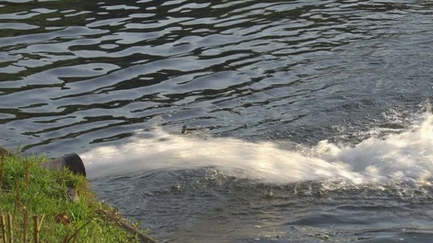 A side view of an embankment pipe, stron... | Stock Video | Pond5