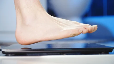 Side view feet step on the weighing scal... | Stock Video | Pond5