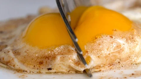 side view fork cutting open egg yolk clo... | Stock Video | Pond5