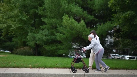 Side view of grandmother using a walker ... | Stock Video | Pond5