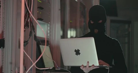 Side view of hacker in black mask steali... | Stock Video | Pond5