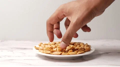 side view of hand pick peanuts from a pl... | Stock Video | Pond5