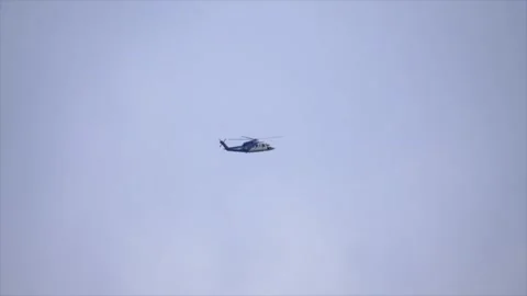 Side View of Helicopter Flying in the Di... | Stock Video | Pond5