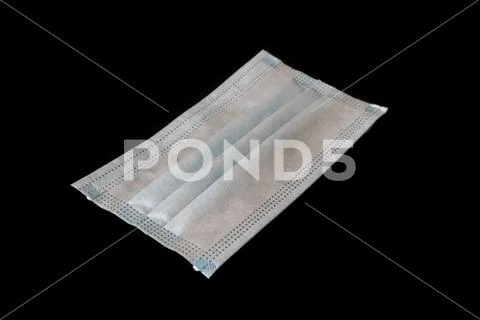 Side view of isolated medical face mask on black background Stock Photo ...