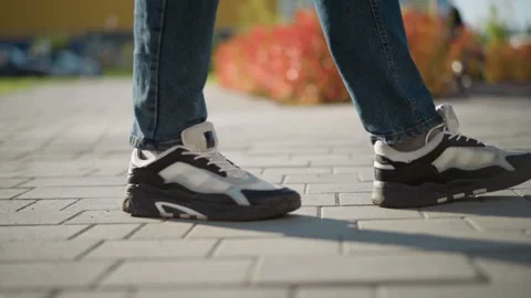 Side view of legs walking on interlocked... | Stock Video | Pond5