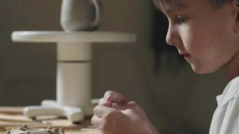 Side view of little boy plays with clay ... | Stock Video | Pond5