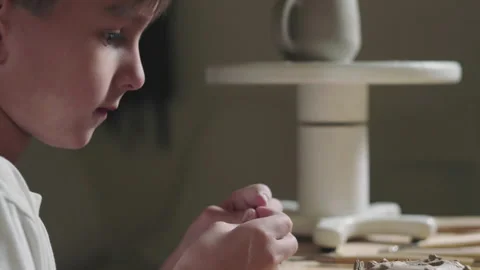 Side view of little boy plays with clay ... | Stock Video | Pond5