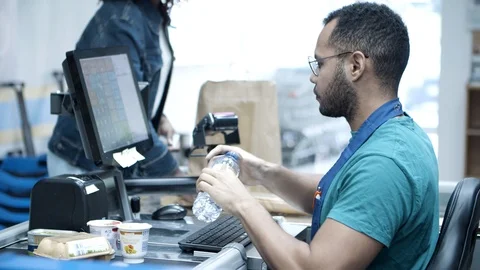 Side view of male cashier scanning goods... | Stock Video | Pond5