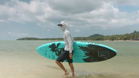 Side view of male surfer in white cotton... | Stock Video | Pond5