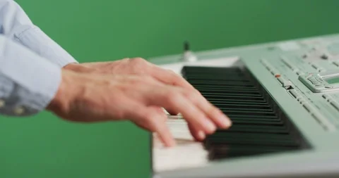 Side view of a man playing the keyboard | Stock Video | Pond5