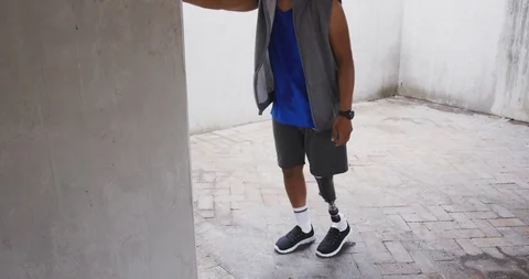 Side view man with prosthetic leg stretc... | Stock Video | Pond5
