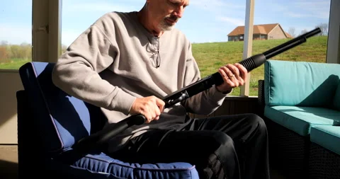 Side view man pumping shotgun and inspec... | Stock Video | Pond5