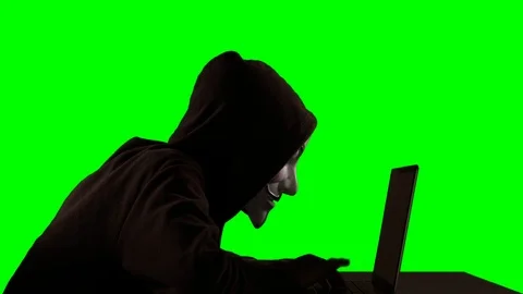 Side view of masked hacker uses a laptop... | Stock Video | Pond5