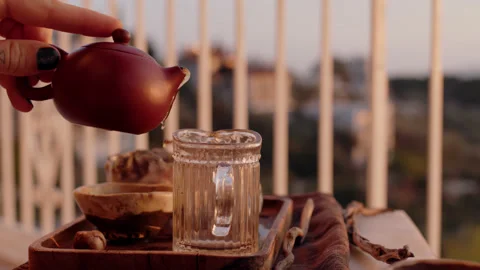 Side view pouring tea from small clay te... | Stock Video | Pond5