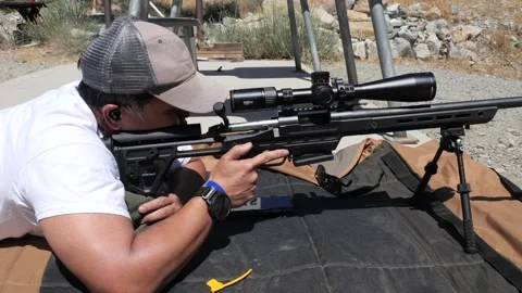 side view of prone man shooting bolt act... | Stock Video | Pond5