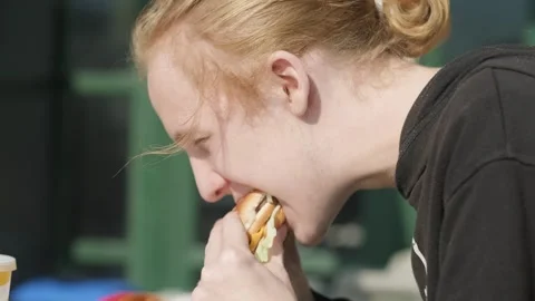 side view red headed teen boy eating Big... | Stock Video | Pond5
