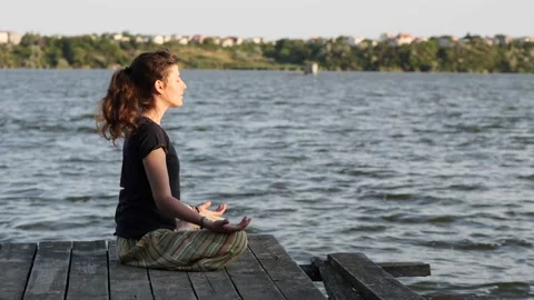 Side view of a slender young woman sitti... | Stock Video | Pond5