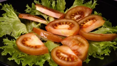 Side view of sliced pink tomato on salad... | Stock Video | Pond5