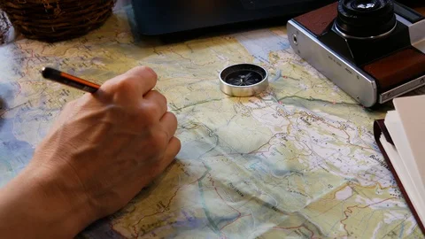A side view of somebody drawing on a map... | Stock Video | Pond5