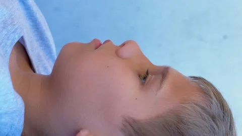 Side view of teenage boy sitting and loo... | Stock Video | Pond5