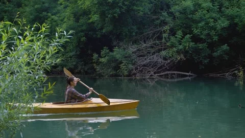 A side view of a traveler on a raft, flo... | Stock Video | Pond5