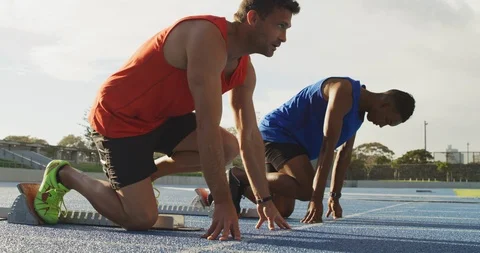 Side view of two athletes beginning race... | Stock Video | Pond5
