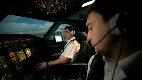 Side view of two professional pilots in ... | Stock Video | Pond5