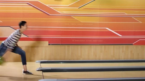 Side View of Woman Throwing Bowling Ball | Stock Video | Pond5