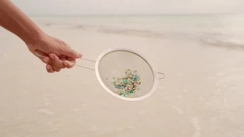Sieve with plastic particles on beach, m... | Stock Video | Pond5