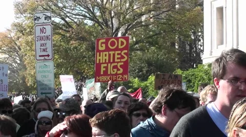 A sign is carried at a rally stating tha... | Stock Video | Pond5