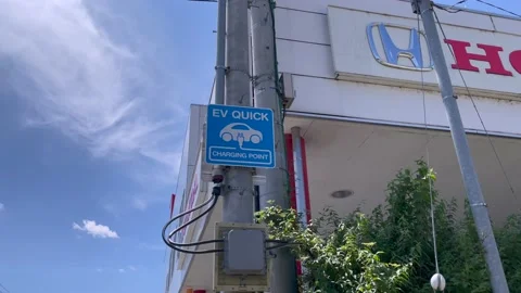 A sign for an EV quick charger outside o... | Stock Video | Pond5