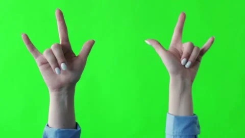 Sign of the horns with fingers on green ... | Stock Video | Pond5