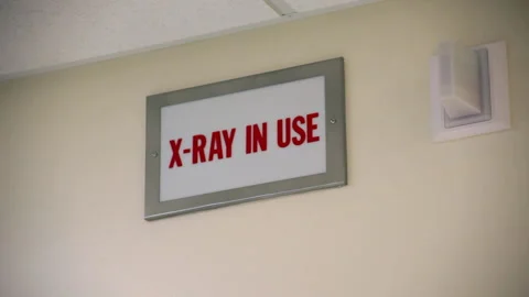Sign stating "X-Ray in Use" on wall in h... | Stock Video | Pond5