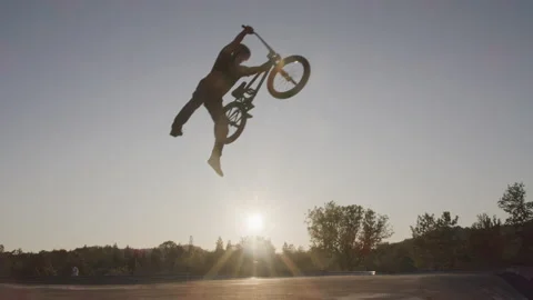 Silhouette of a BMX Biker Doing a Trick ... | Stock Video | Pond5