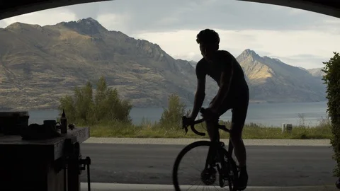 Silhouette cyclist starting bike ride tr... | Stock Video | Pond5