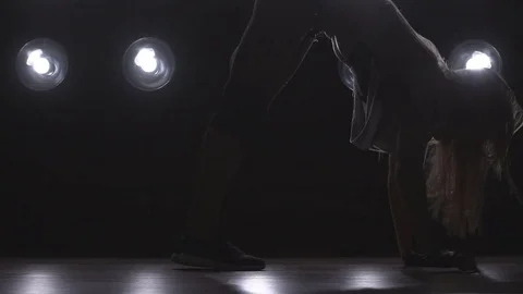 Silhouette of a girl dancing on the back... | Stock Video | Pond5