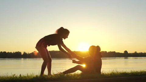 Silhouette of girl giving helping hand t... | Stock Video | Pond5