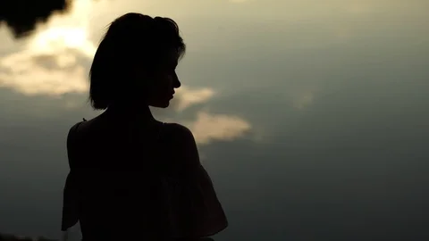 Silhouette of a girl turning head on a s... | Stock Video | Pond5